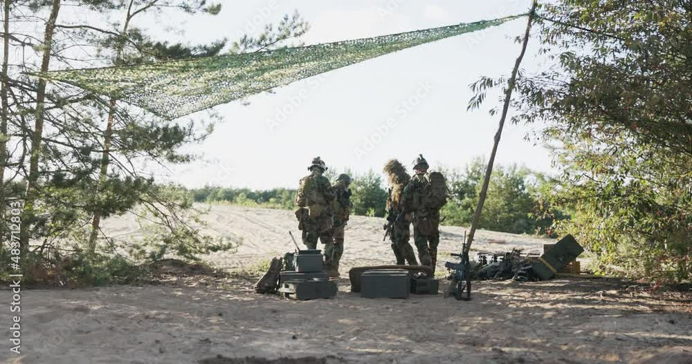 Soldiers go out into field from military base where they leave crates ...