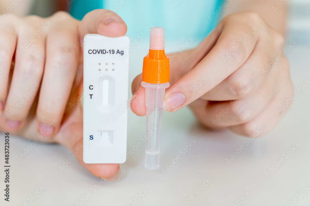 Hands holding Covid-19 rapid antigen test kit ready to use. Tube and ...