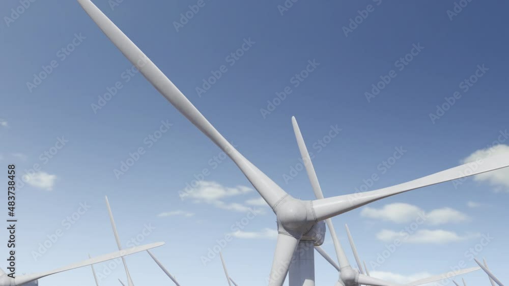 Rotation of wind turbine blades. Blue sky on background. Green energy ...
