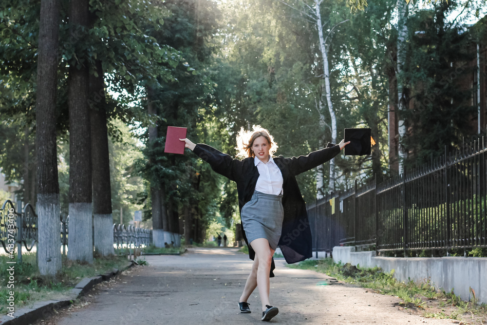 Cute teenage graduate girl laughing and having fun. No school, back to ...