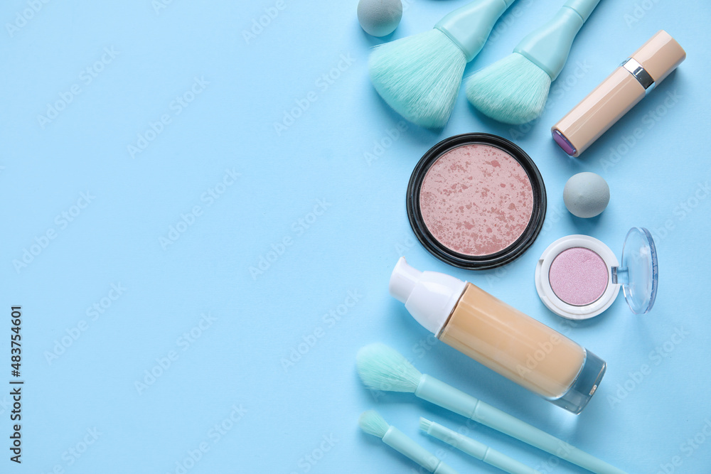 Different makeup products on blue background Stock Photo | Adobe Stock
