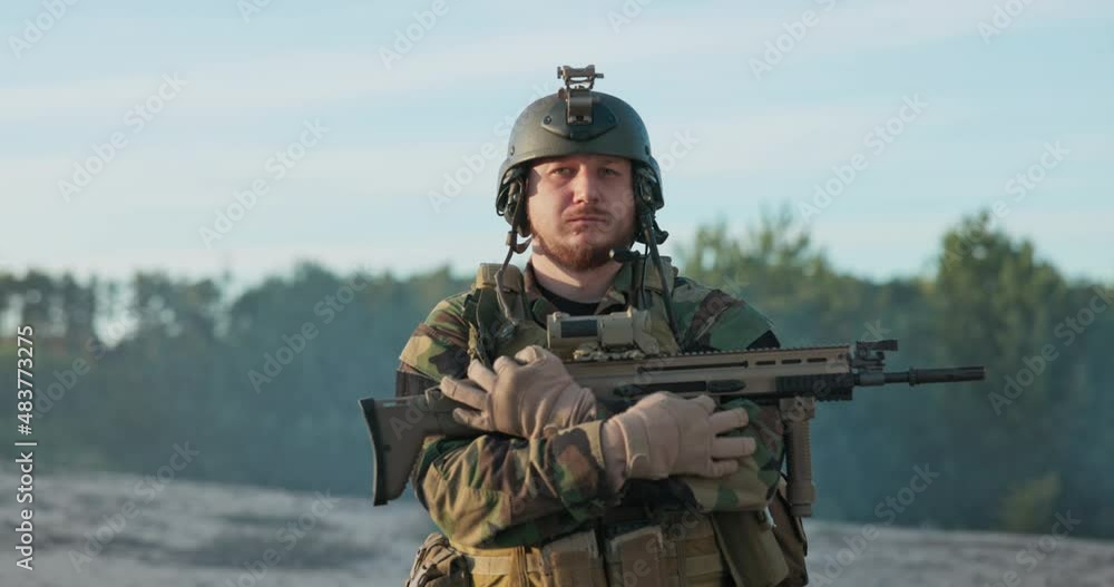 Portrait of soldier dressed in moro uniform, helmet and equipment belt ...