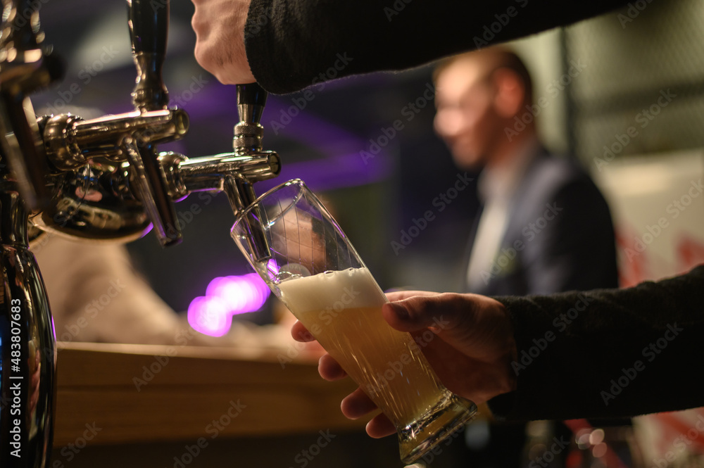 Hand of bartender using beer tap while working in a bar Stock Photo ...