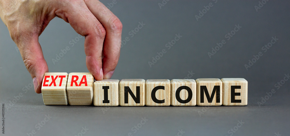 Extra income symbol. Businessman turns wooden cubes and changes concept ...