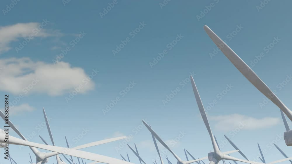 Rotation of wind turbine blades. Blue cloudy sky on background. Green ...