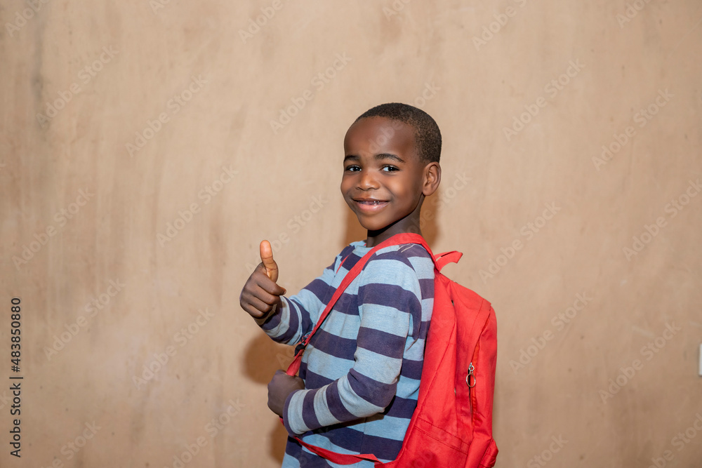 Excited African schools boy carrying schools bag getting ready for ...