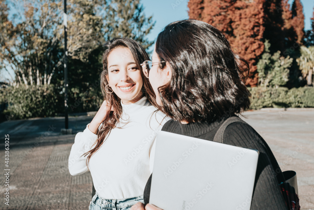 Two friends studying together at university campus walking going to ...