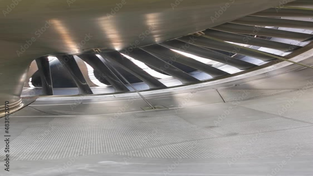 Aircraft jet engine fan blades are rotating. An engineer checks ...