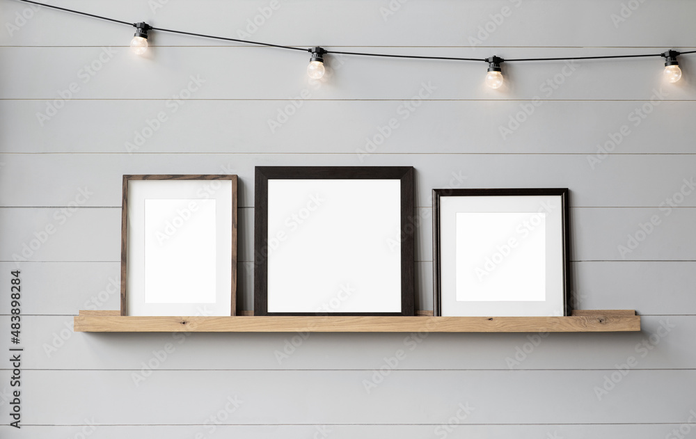 Three blank picture frames mockup on gray wall. Templates for painting ...