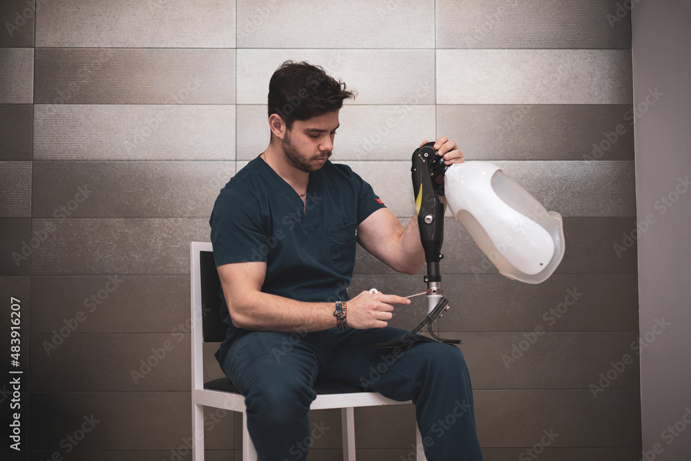 an orthopedist fixing a prosthetic leg for an athlete.bionic leg. Stock ...