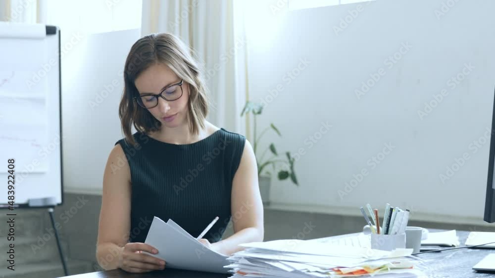 Video of beautiful and concentrated business woman writing on a paper ...