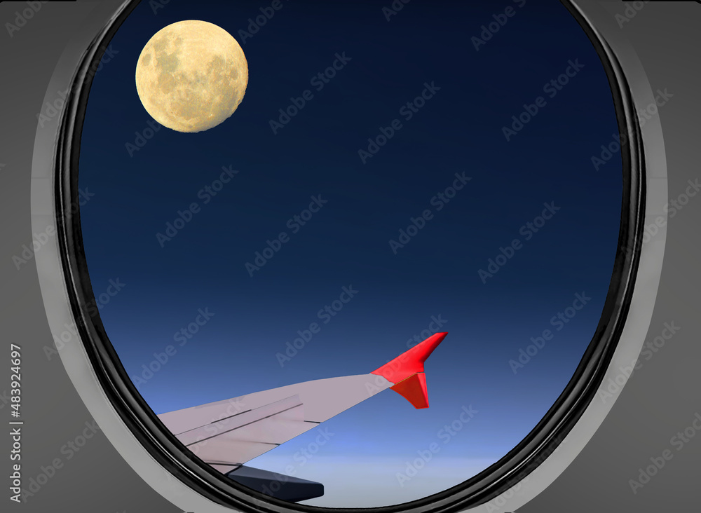 airplane window view during a night flight above clouds with moon and ...