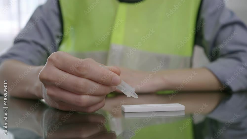 Close-up hand of engineering woman drop liquid rapid antigen self-test ...
