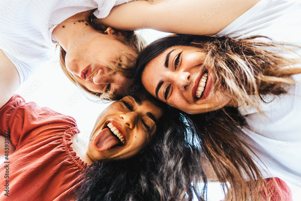 Best friends take a selfie from below with smartphone on vacation ...