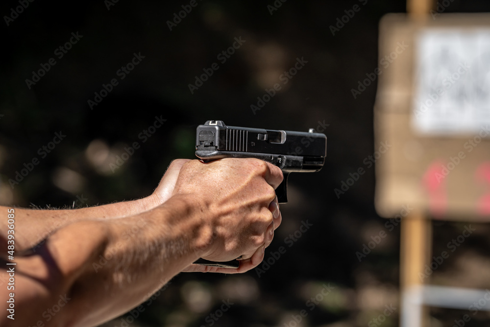 shooting from a pistol at a target on a shooting range Stock Photo ...