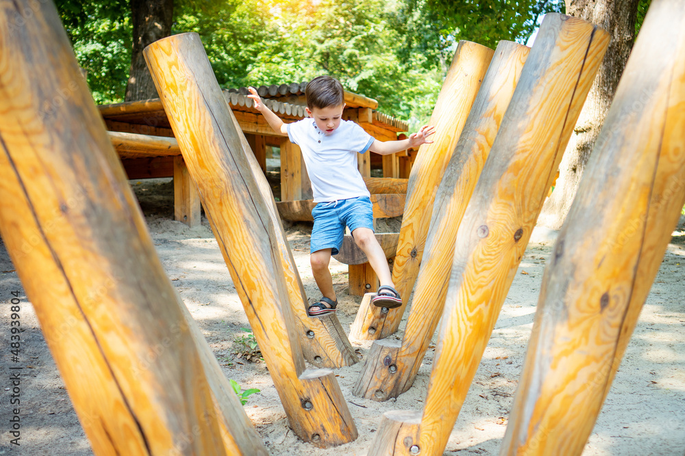 Children's obstacle course on a modern playground. Kid crossing a ...