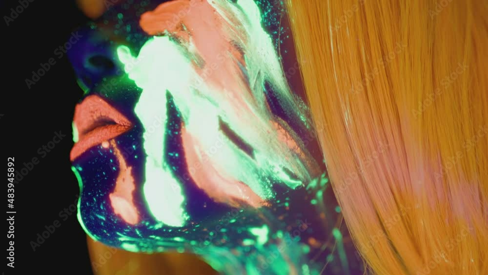 Fluorescent body art. Young lady with neon makeup and orange wig ...