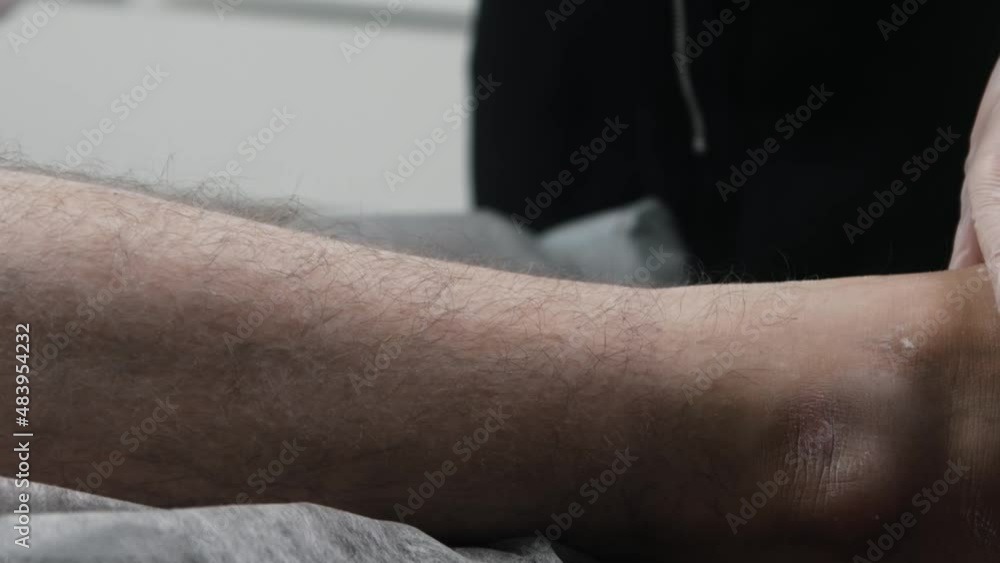 Waxing procedure - epilation master smearing talc powder on the leg of ...