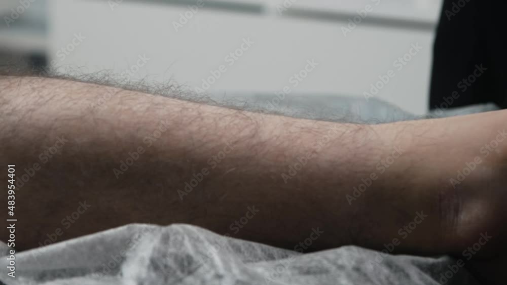 Waxing procedure - epilation master smearing talc powder on the leg of ...