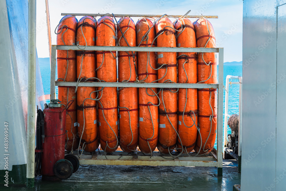 Orange inflatable lifeboats on ferry deck for emergencies and maritime ...