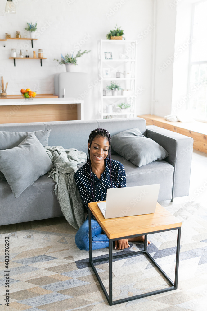 Beautiful young black woman has a zoom call remote work or study online ...