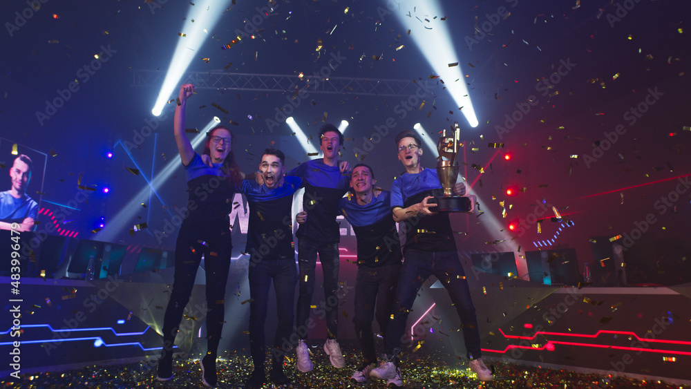 Professional cybersport team of gamers winners with golden trophy ...