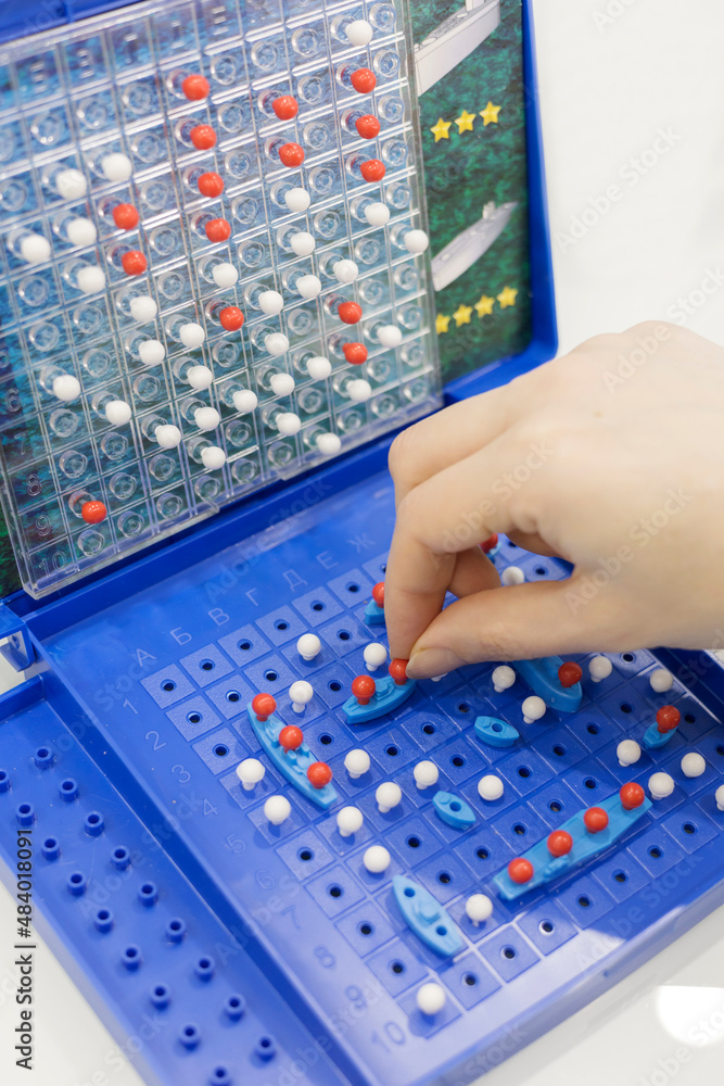 Game-sea battle closeup. Toy warships and submarine are placed on the ...