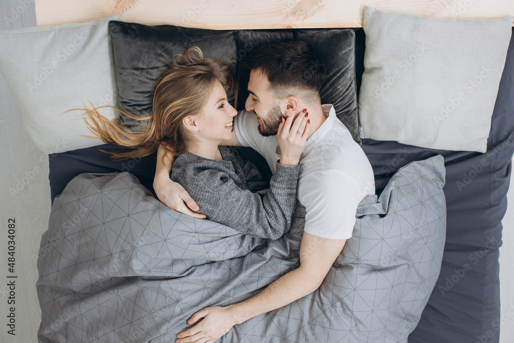 Sensual couple in bed cuddling Stock Photo | Adobe Stock