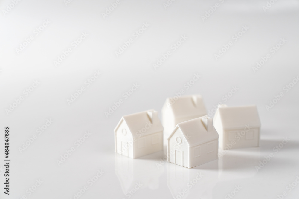 Miniature 3D printed model house on white background for home or real ...