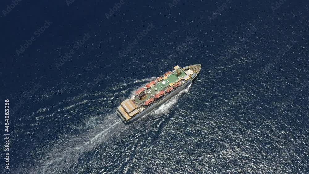 Aerial footage of ultra large container ship at sea or open ocean. A ...