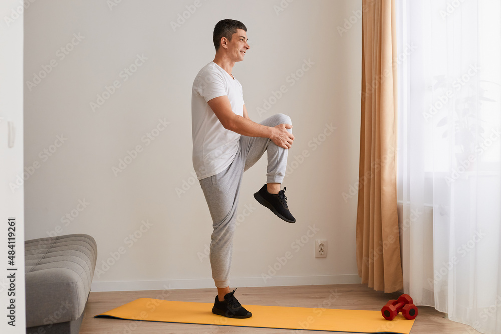 Portrait of athletic man wearing sportswear doing sport standing with ...