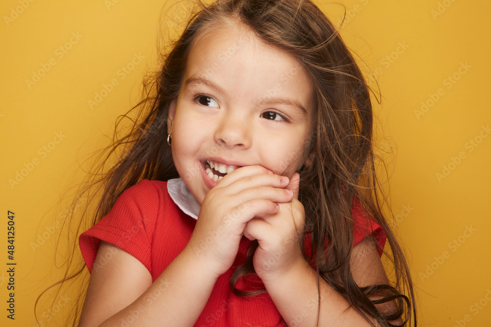 Cute little girl who puts a radiant smile on her face accompanied by ...