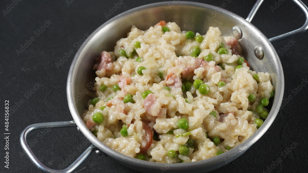 Classic italian risotto with peas, cheese parmesan, prosciutto. Risi e ...