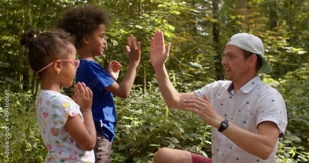 Father teaches children playing with hands. Patty Cake game is easiest ...