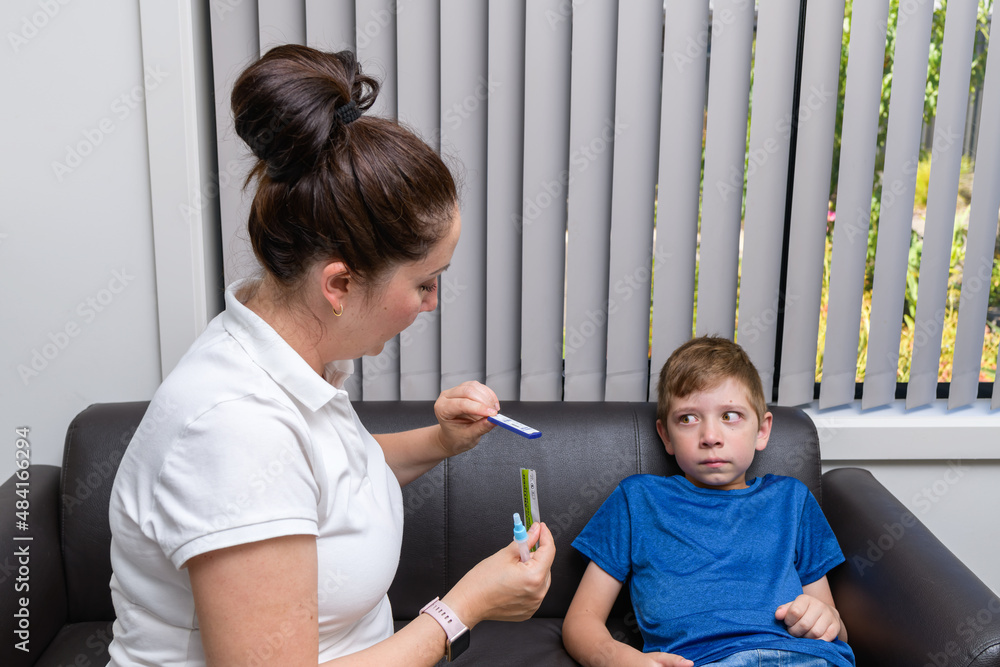 Mother going to do the COVID-19 rapid antigen test for her child at ...