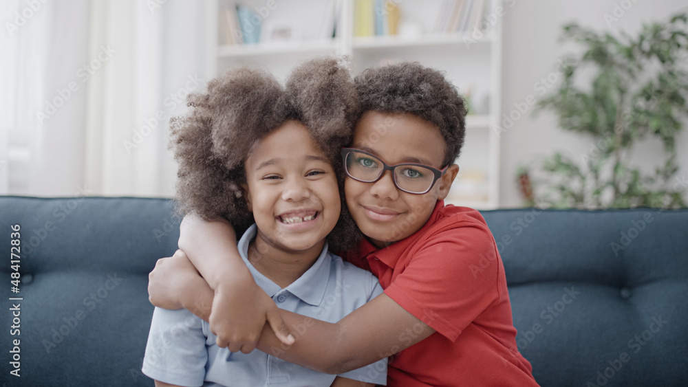 Happy african american kids hugging and smiling on camera, best friends ...