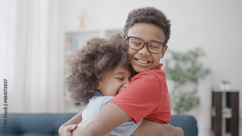 Excited black siblings hugging smiling, friendship between brother and ...