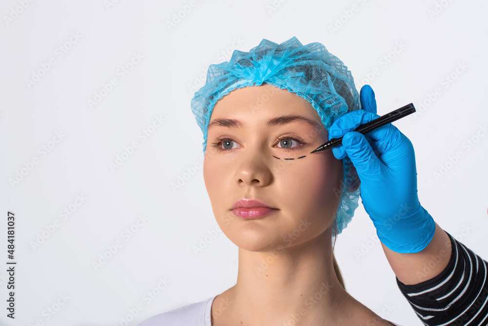 Pretty girl with dark eyebrows wearing blue medical hat at studio ...