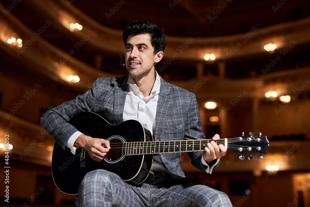 caucasian european Man in elegant classic suit plays and sings while ...