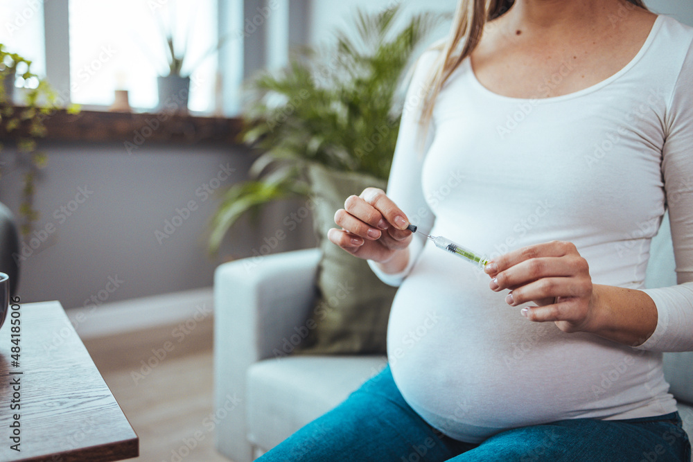 Woman injects a hormone into her abdomen to stimulate follicular growth ...