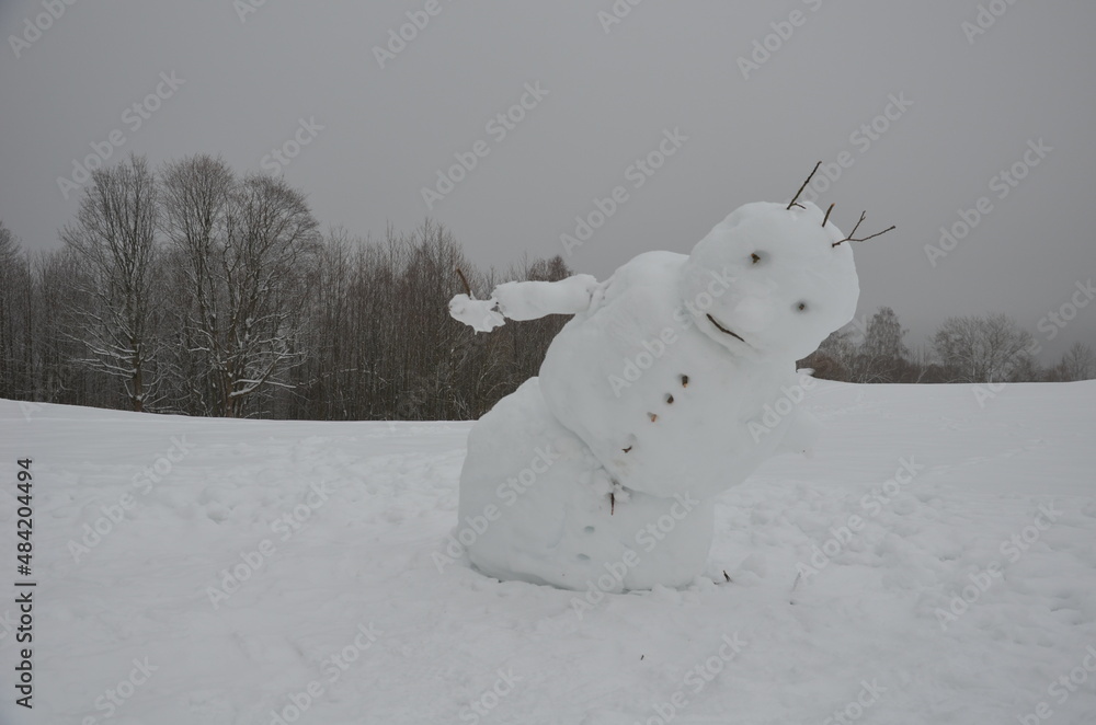 The big snowman has a tilted body that looks like he's falling. has ski ...