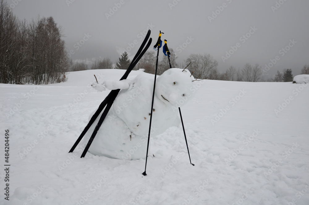 The big snowman has a tilted body that looks like he's falling. has ski ...