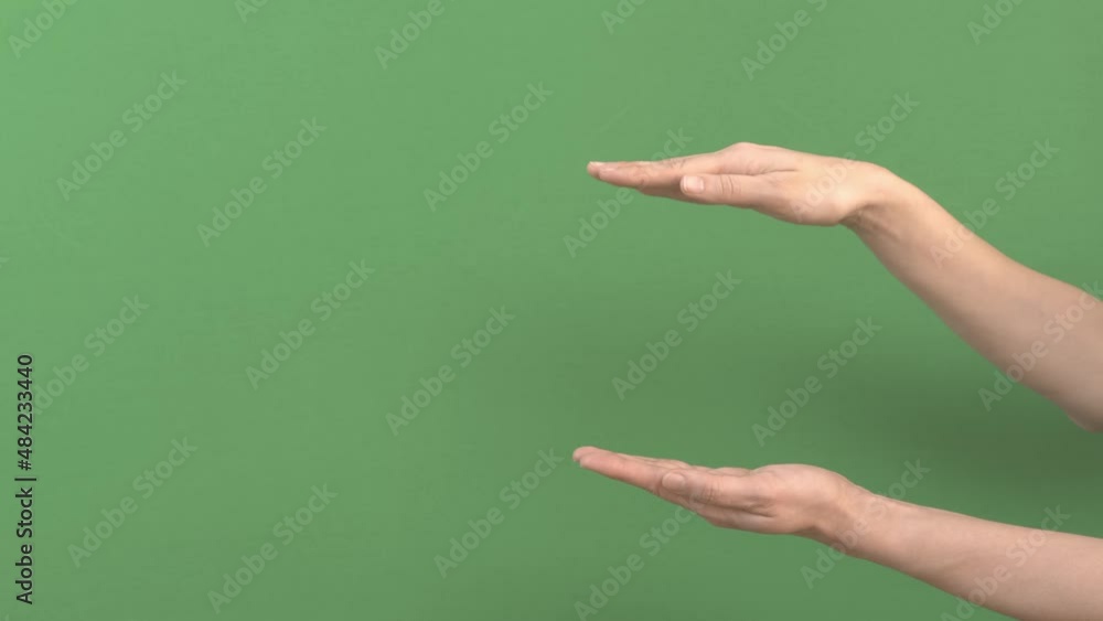 Woman holding hands as showing something virtual and invisible between ...