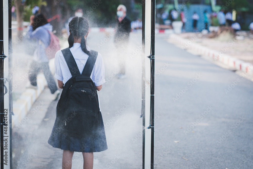 Students walk past alcohol sprayers to prevent Covid-19 in schools ...