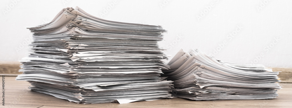 bundles bales of paper documents. stacks packs pile on the desk in the ...