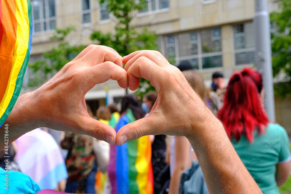 members of LGBTq movement, Gay pride parade in city with rainbow flags ...