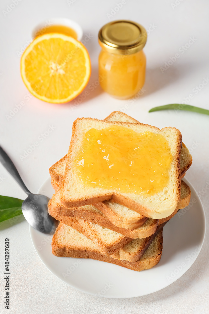 Toasts with tasty orange jam on light background Stock Photo | Adobe Stock