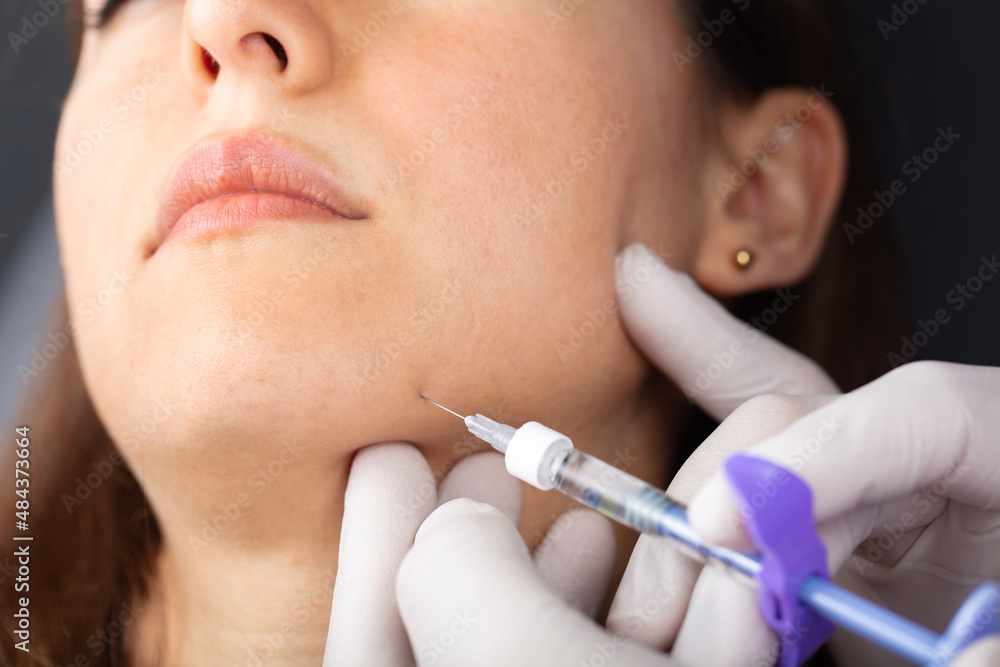 Botox injection to the face in the chin area. aesthetics, medicine ...