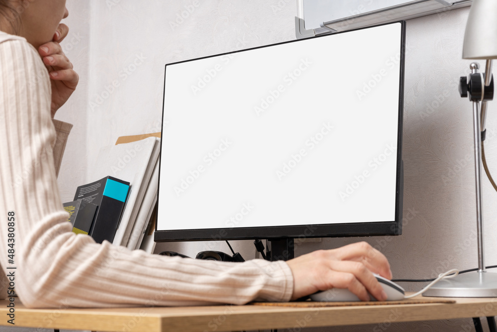 Woman searching information on her computer.Blank screen of monitor ...