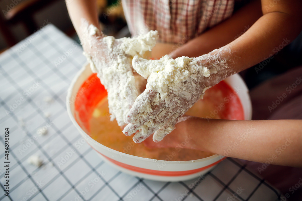 The child kneads the dough, makes artificial snow at home. Experiments ...